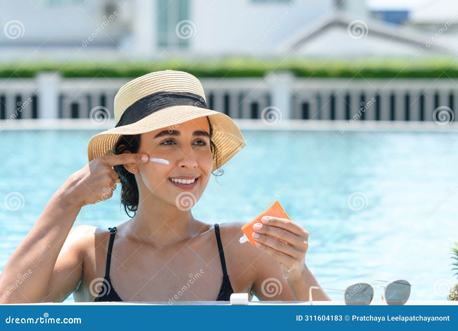 Sunscreen Lotion In Woman Hand And Applied To Her Face Girl Puts
