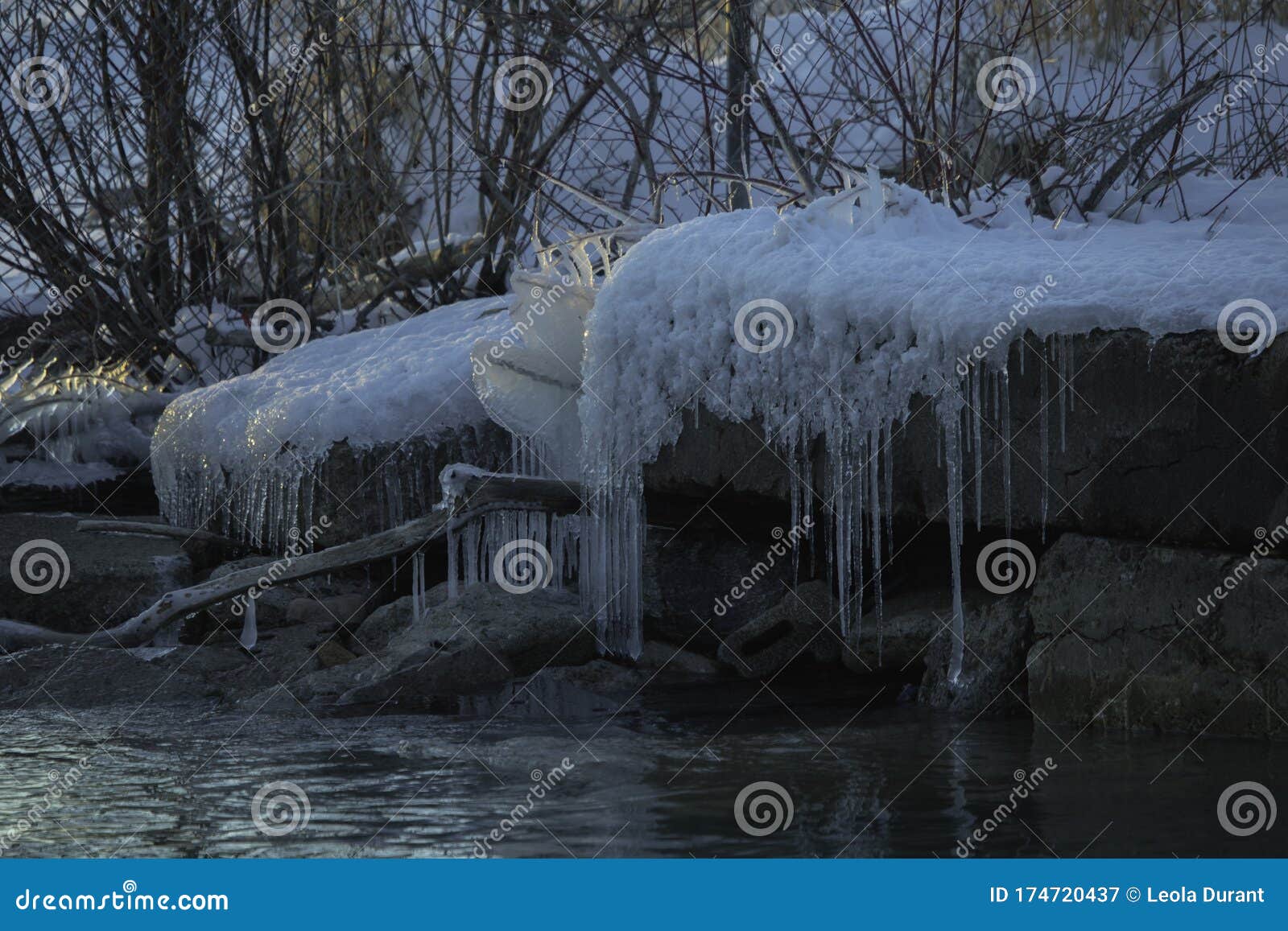 Icicles and Snow on Rocks stock image. Image of water - 174720437