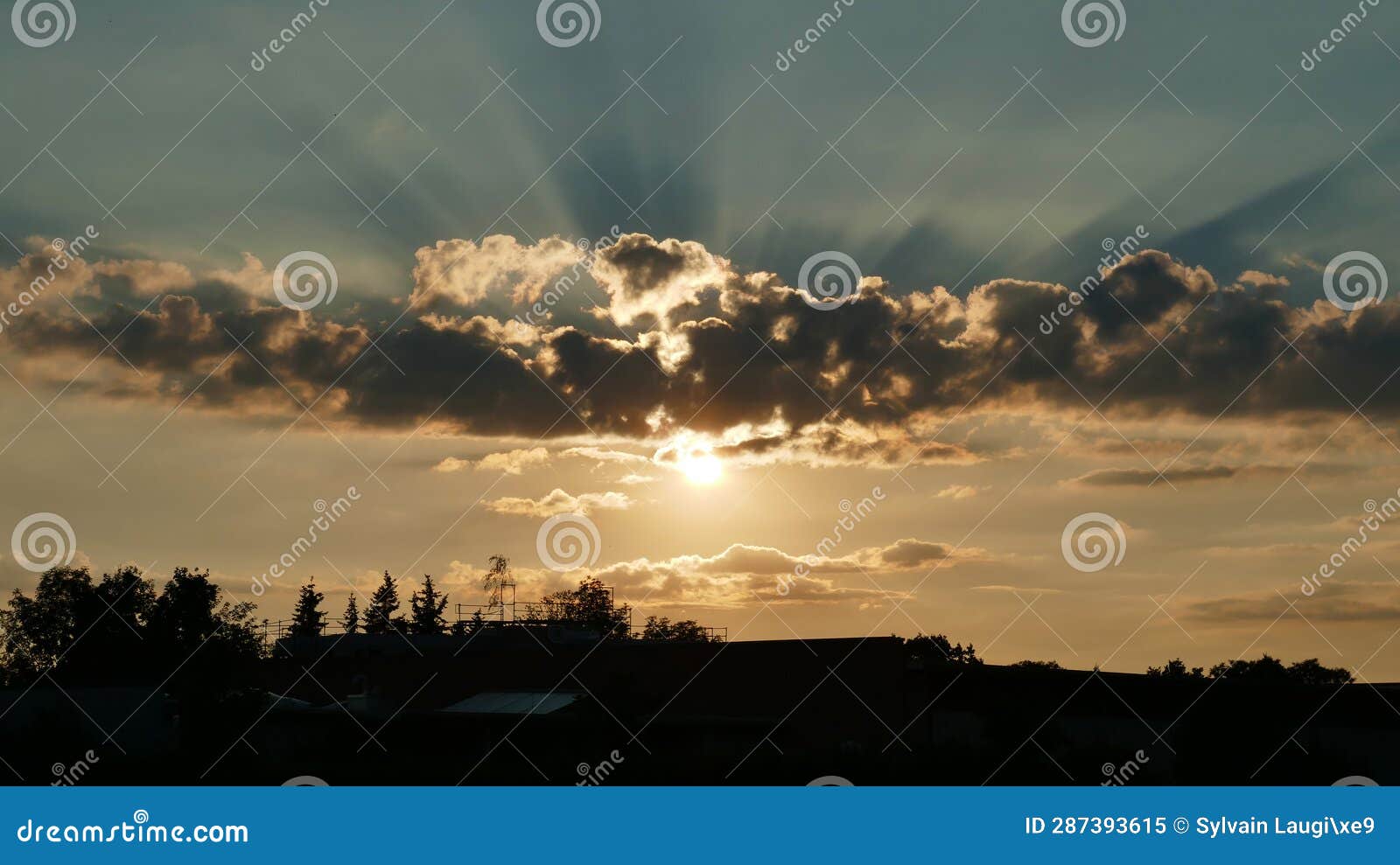 Sunset with Back-lit Clouds and Light Rays in the Sky, Over Trees and ...