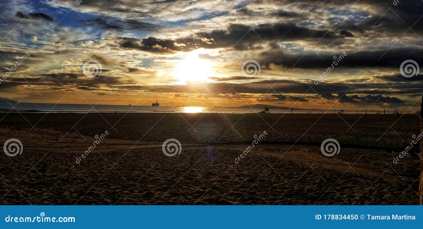 Sunset at the Beach with Blue and Yellow Dark Clouds Stock Photo ...