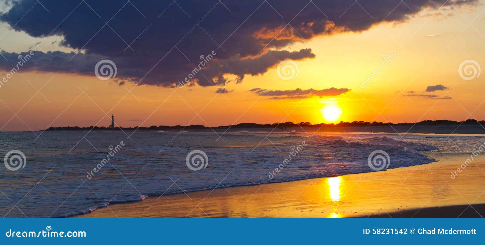 Sunset on the Beach with a Lighthouse Stock Photo - Image of waves ...