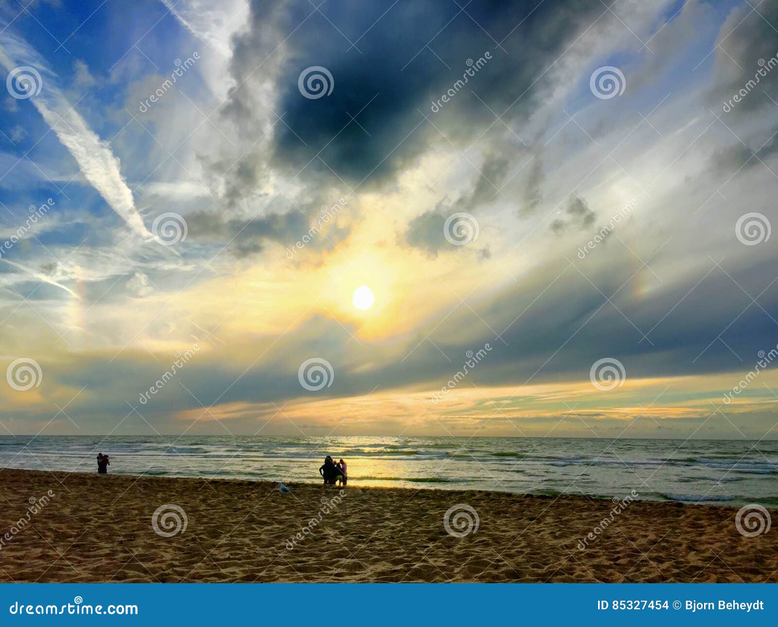 Sunset at the beach stock photo. Image of coast, people - 85327454