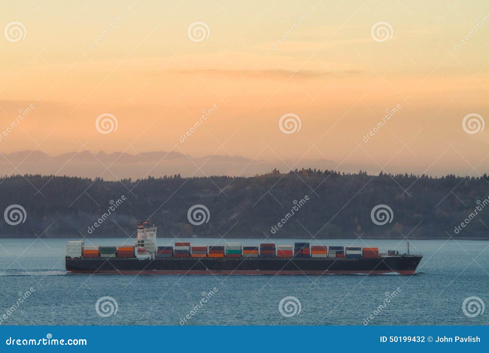 Sunset Behind a Cargo Freighter Ship for International Import and ...