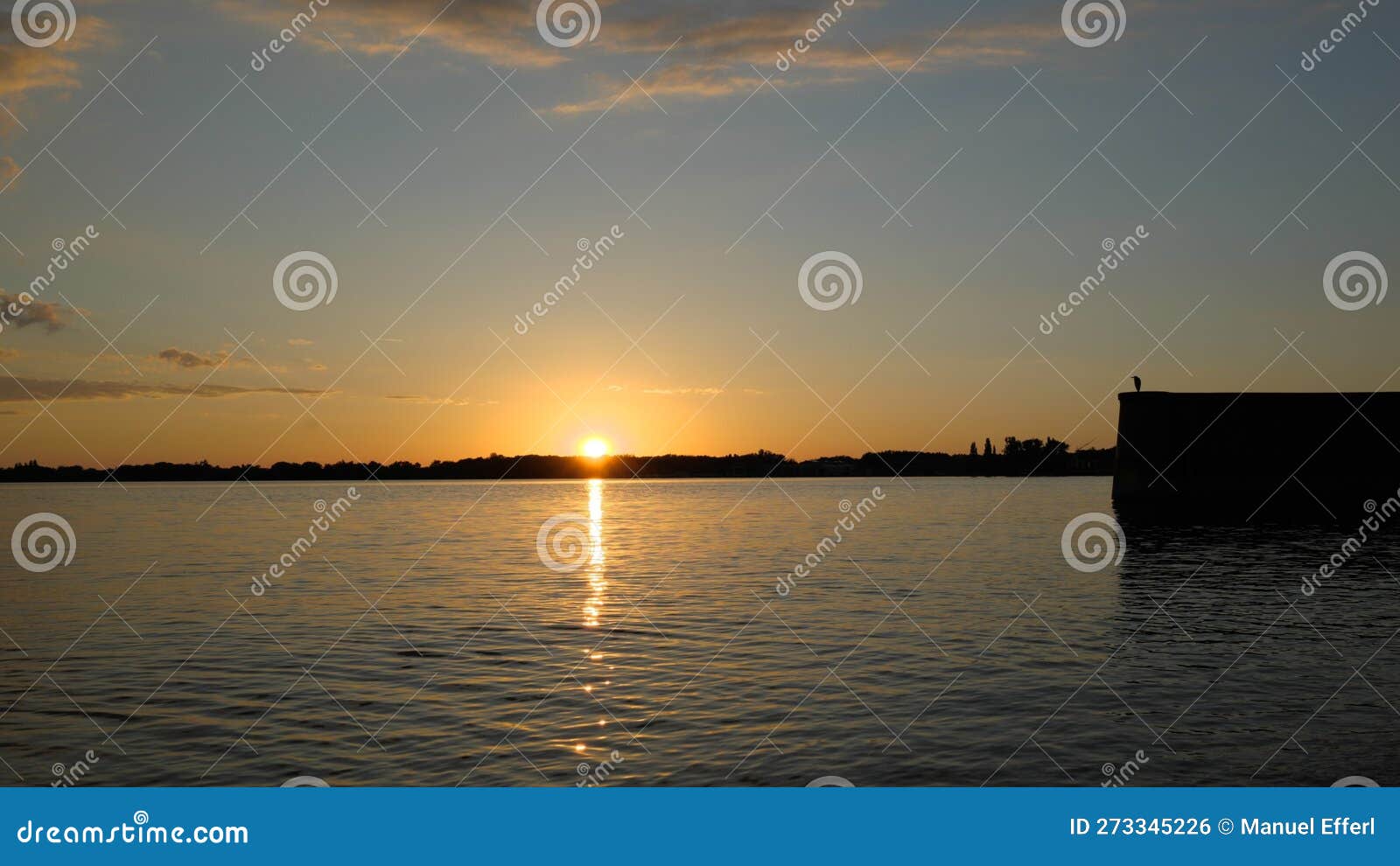 Sunset Behind Horizon with Reflection and Glitter on Lake Stock Photo ...