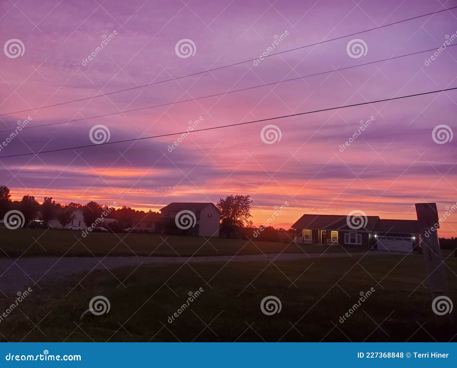 Sunset behind houses stock photo. Image of dusk, cloud - 227368848