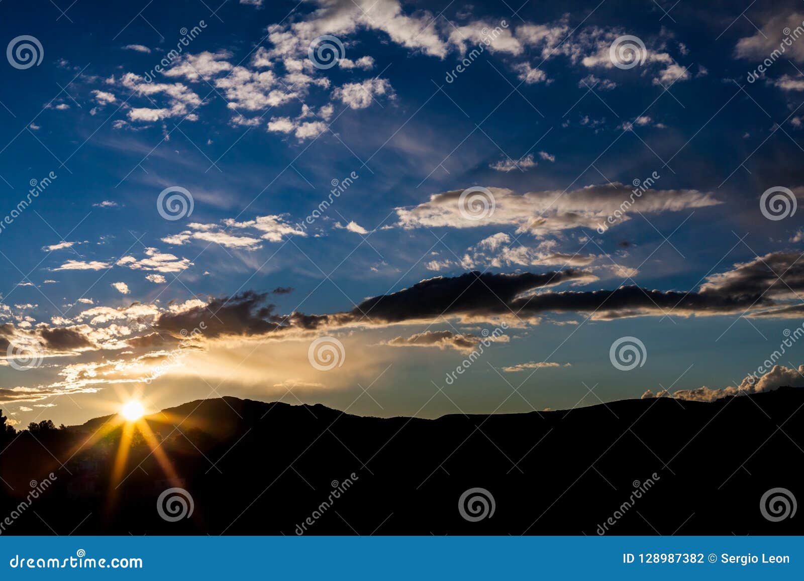 Sunset Behind the Mountains Stock Photo - Image of horizon, rays: 128987382
