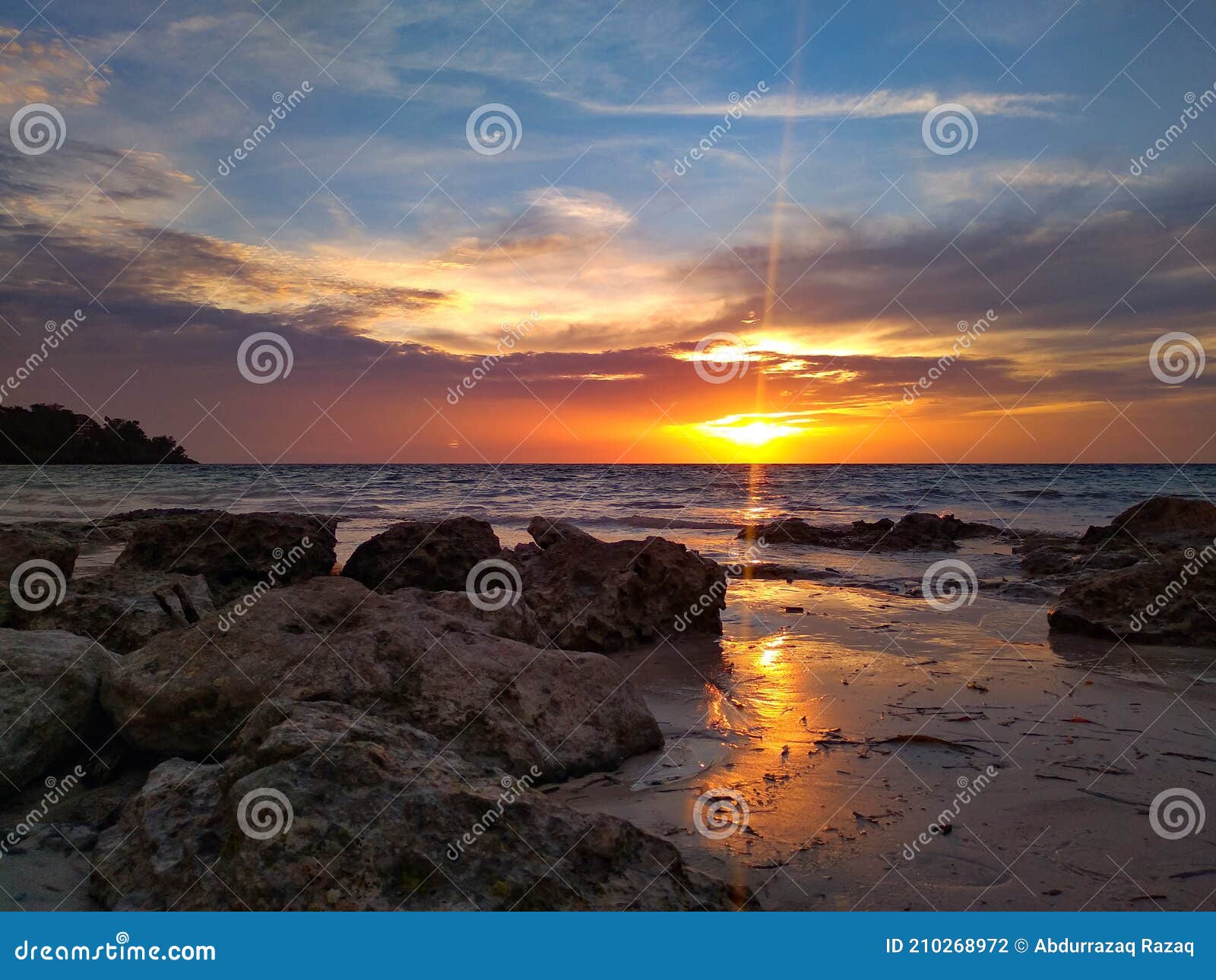 Sunset from behind a rock stock photo. Image of morning - 210268972