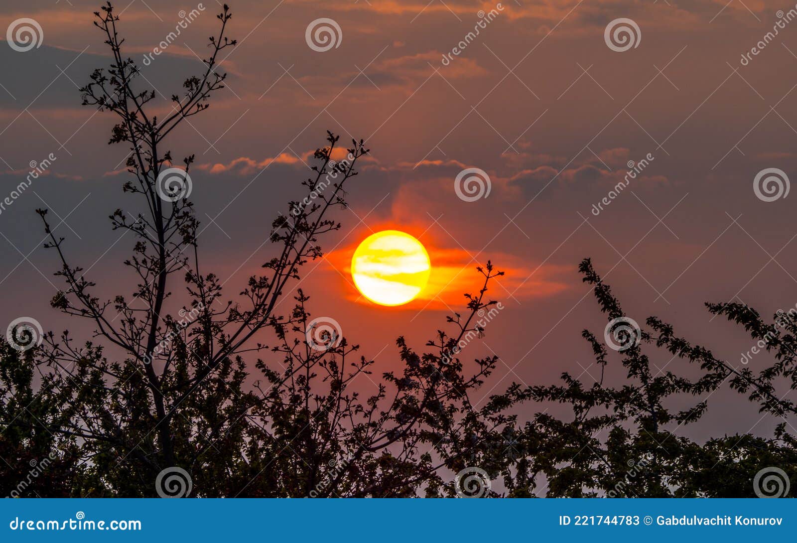 Sunset with Bright Round Sun Disk Behind Dark Clouds Stock Image ...