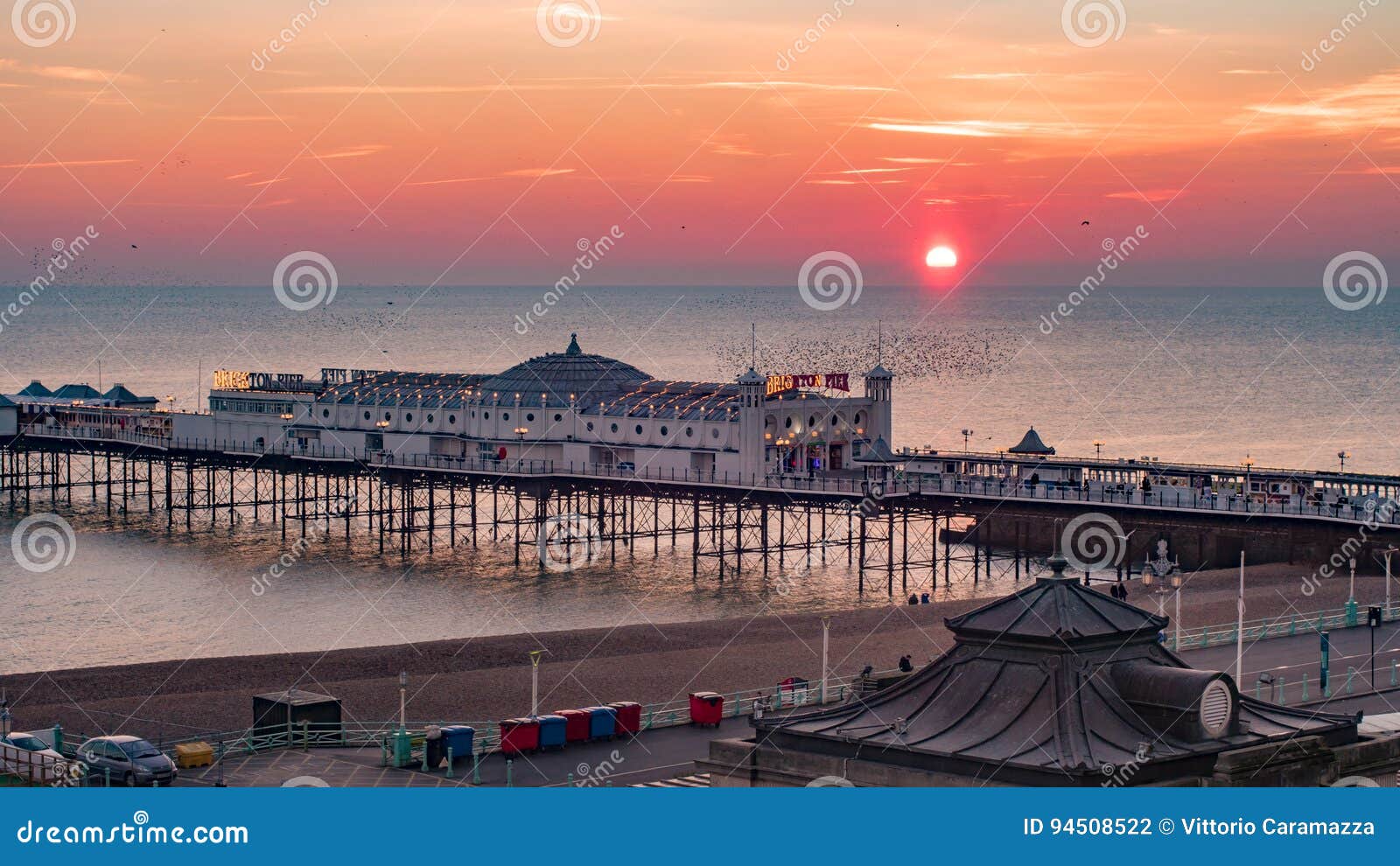 Sunset on Brighton Pier with a Flock of Birds Editorial Photography ...