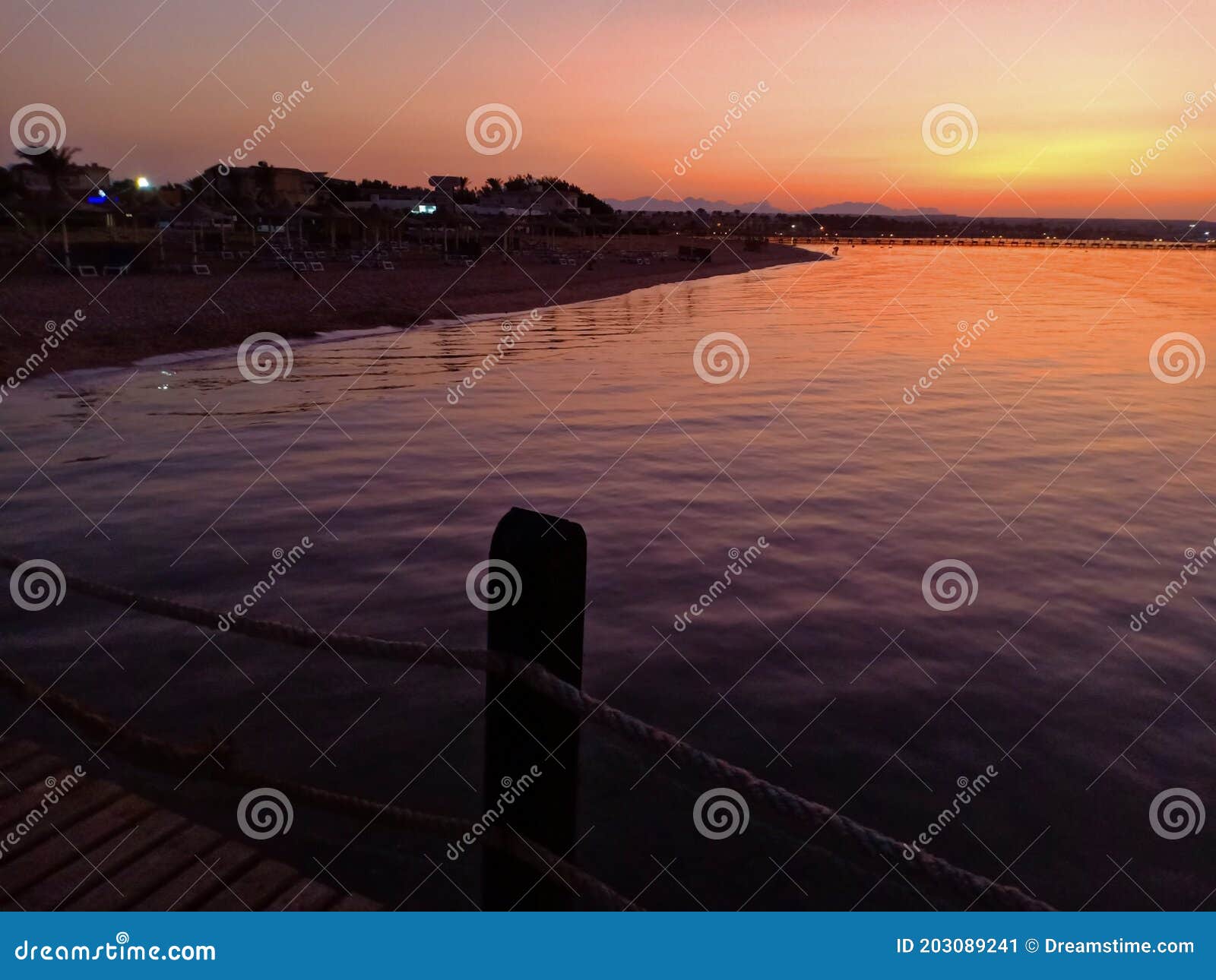Sunset on calm water stock image. Image of beach, evening - 203089241