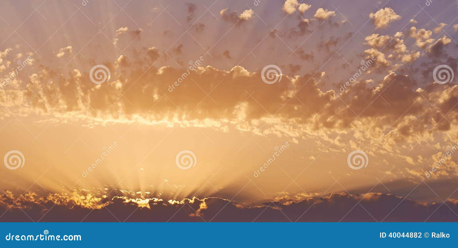 Sunset through the clouds stock photo. Image of cloud - 40044882