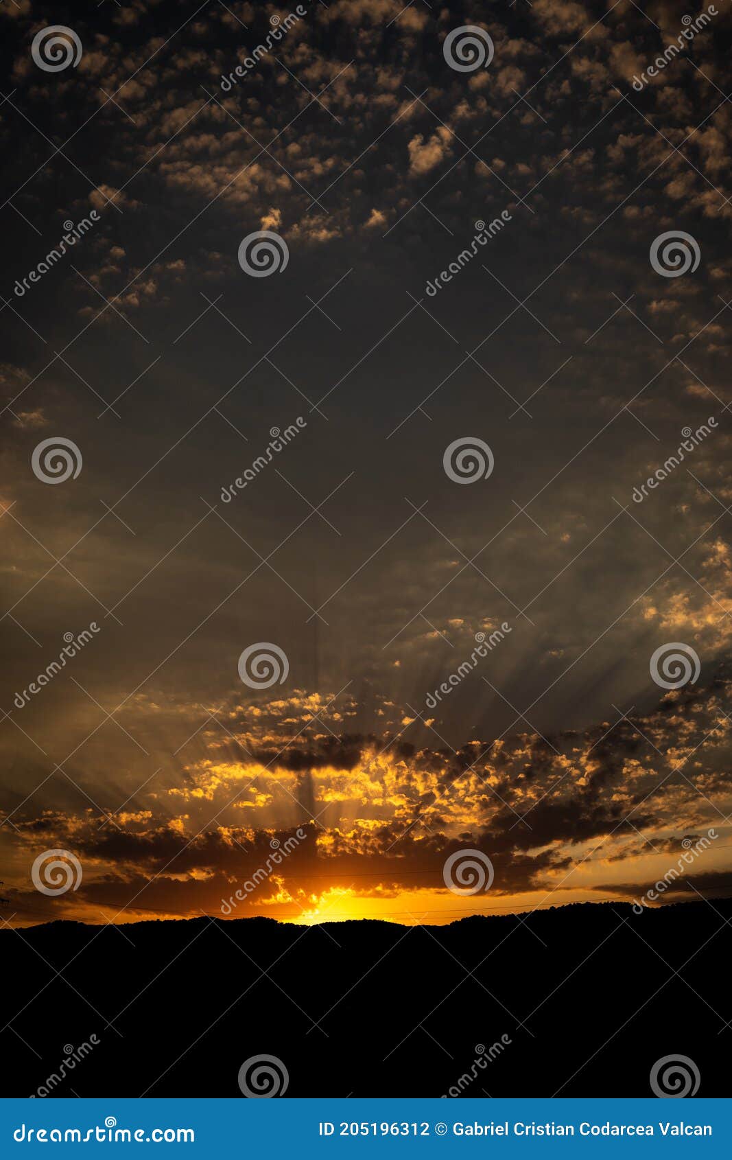 Sunset on a Cloudy Day with Sun Rays Stock Photo - Image of dusk ...