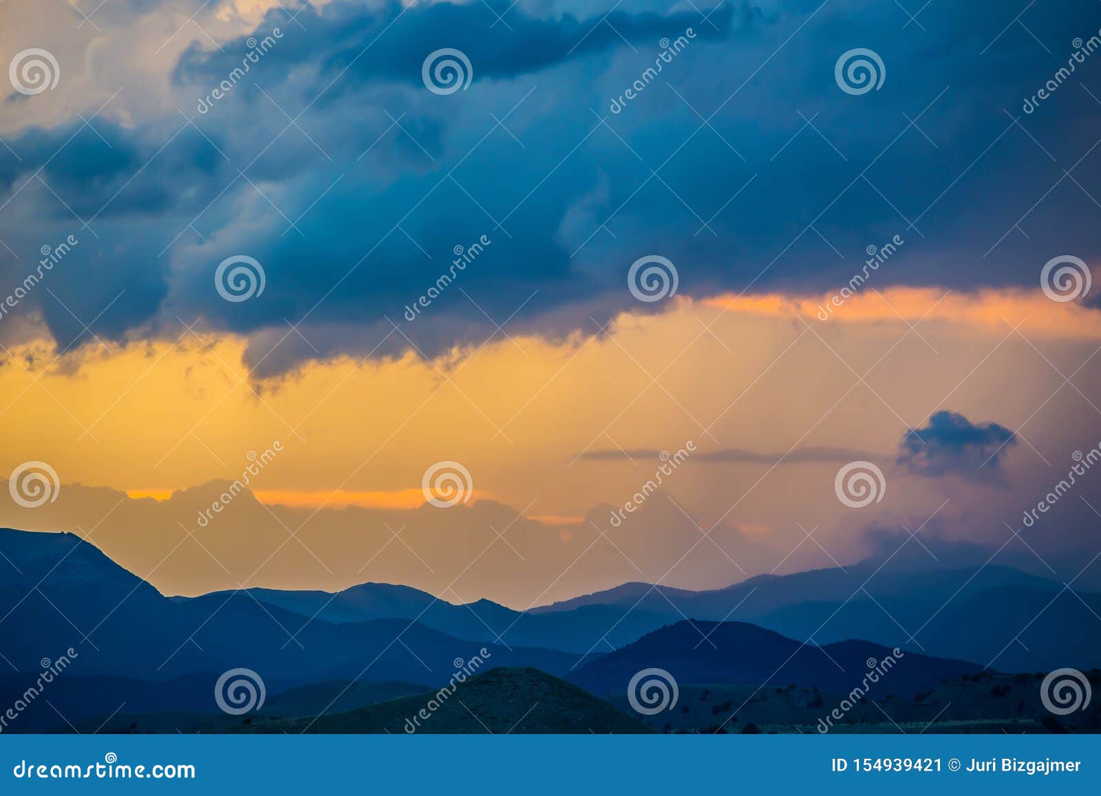 Sunset in the Cloudy Sky Over the Mountains Stock Image - Image of ...
