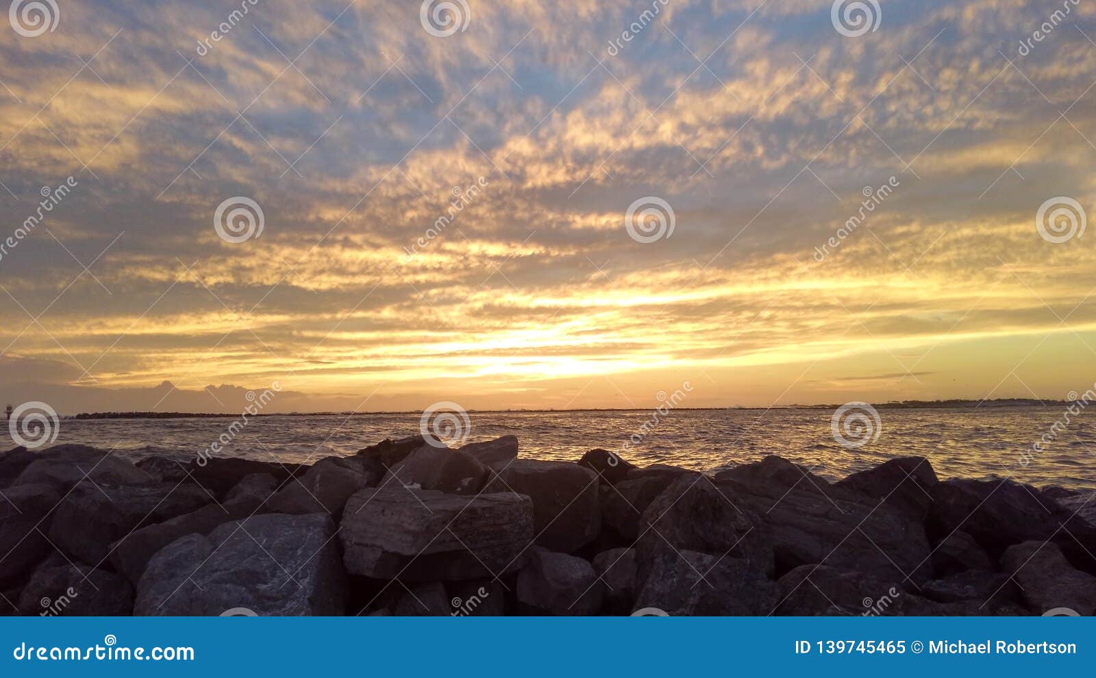 Sunset over the rocks stock image. Image of destin, sunset - 139745465
