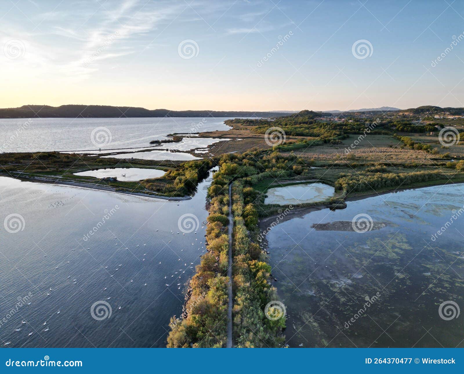 Sunset Drone View of a Jetty Walkway in a Blue Lagoon with Mountains in ...