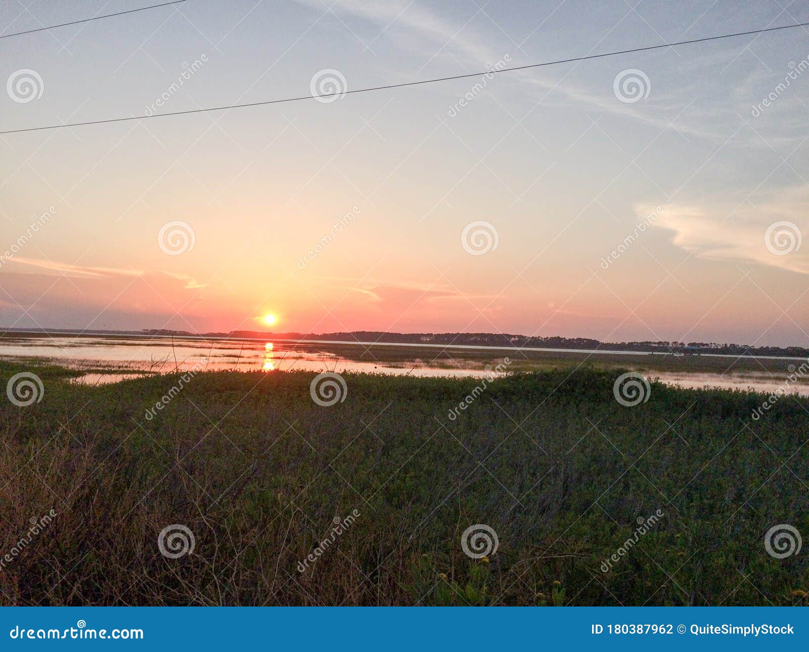 Sunset dusk over marsh stock photo. Image of clouds - 180387962