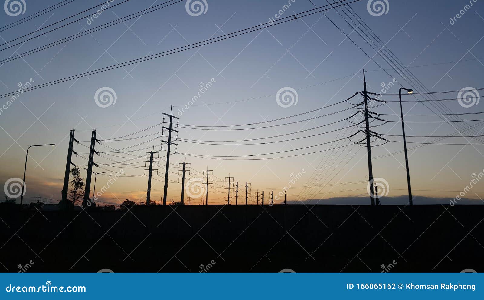 The Sunset and High Voltage Electric Pole Silhouette Stock Photo ...