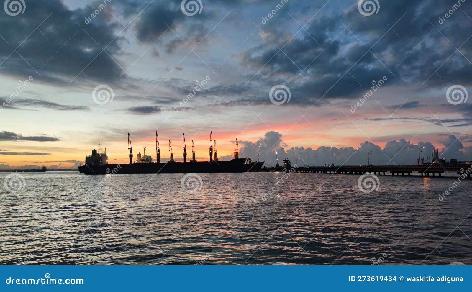 Sunset at jetty with ship stock photo. Image of sunset - 273619434