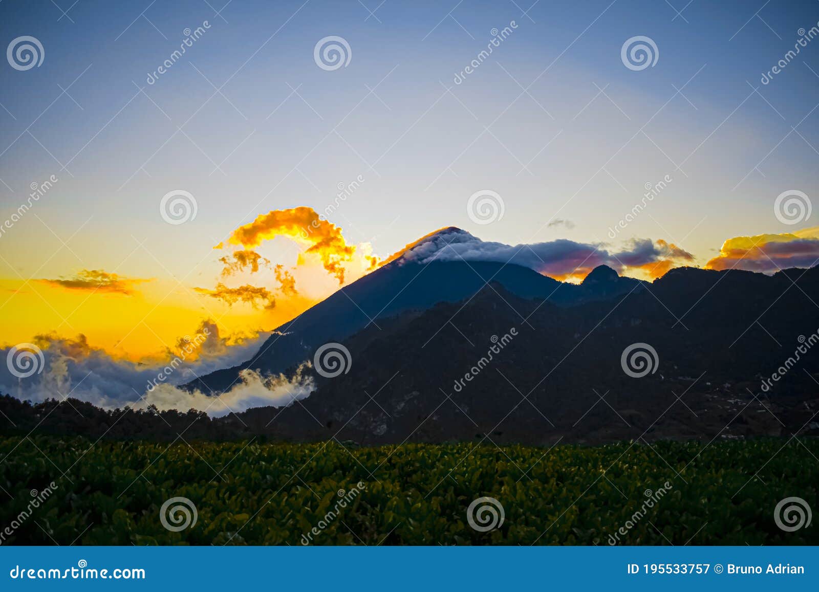 Sunset Landscape, with Red Clouds and Sun Setting Behind the Volcano ...
