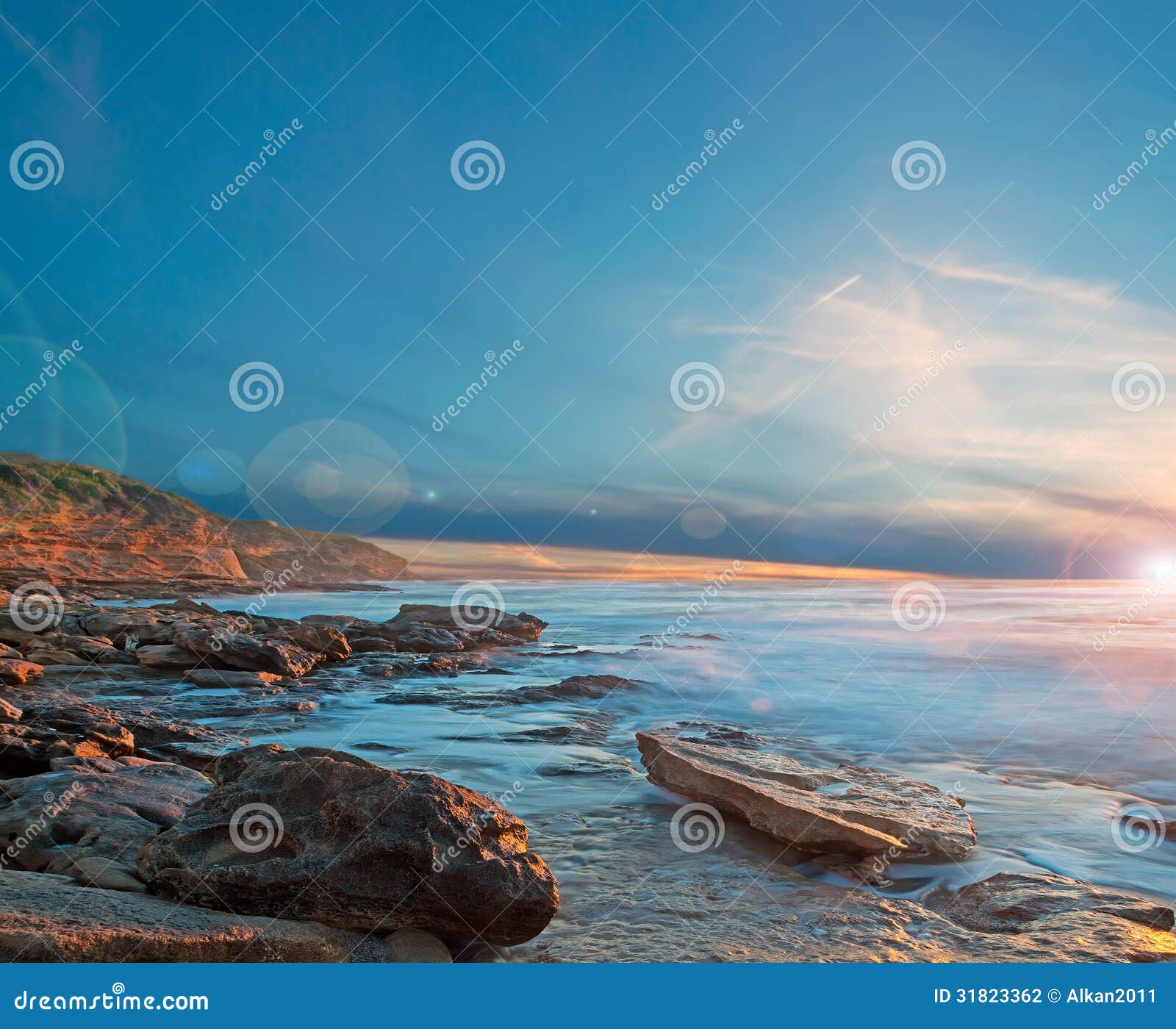 Sunset and Lens Flare by the Shore Stock Photo - Image of colorful ...