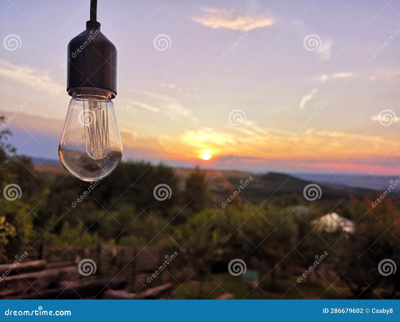 Sunset with a light bulb stock photo. Image of light - 286679602