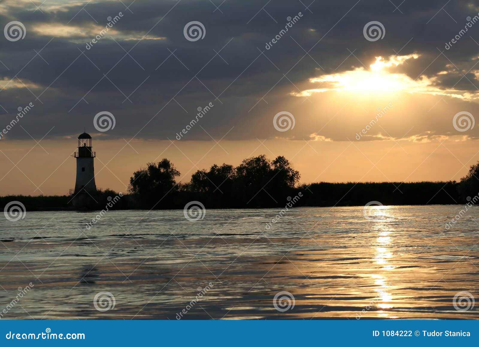 Sunset and lighthouse stock photo. Image of water, evening - 1084222