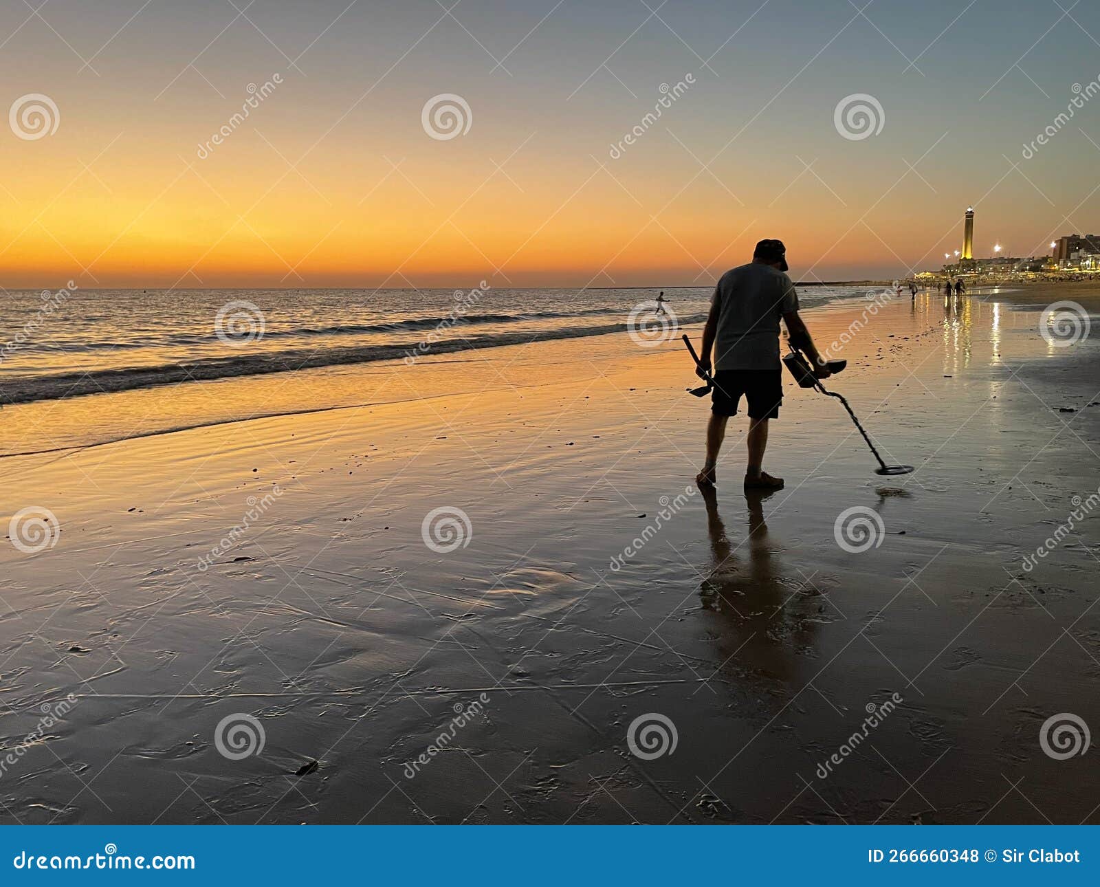 Sunset with Man with Metal Detector on Sandy Beach Stock Photo - Image ...