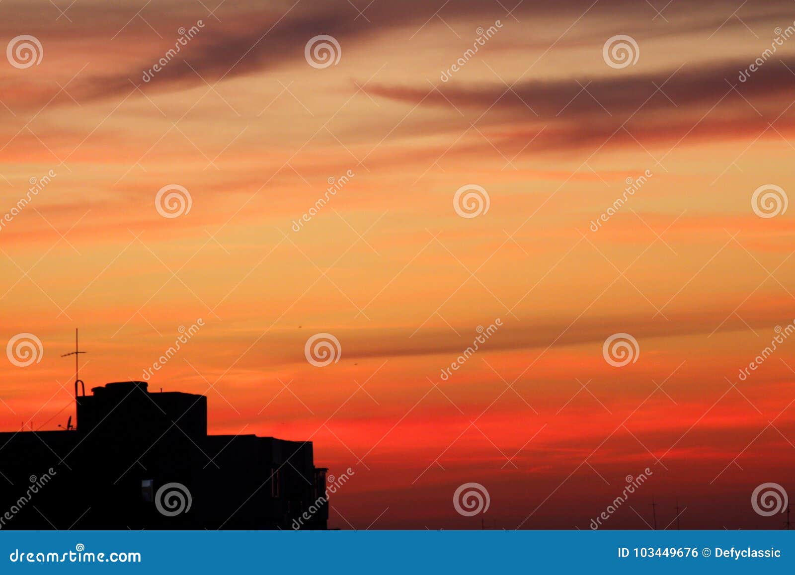Sunset over a building. stock photo. Image of colors - 103449676