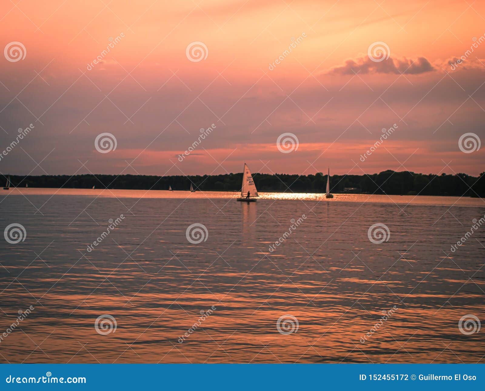 Sunset Over a Calm Lake with Sailing Boats Stock Photo - Image of ...