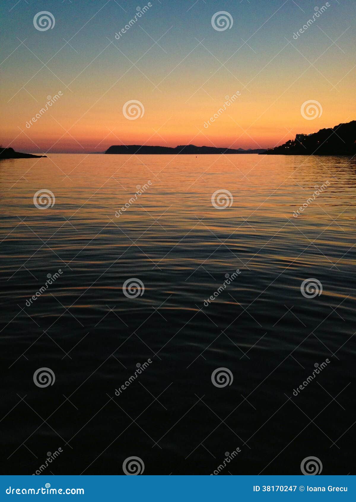 Sunset over calm waters stock image. Image of land, setting - 38170247