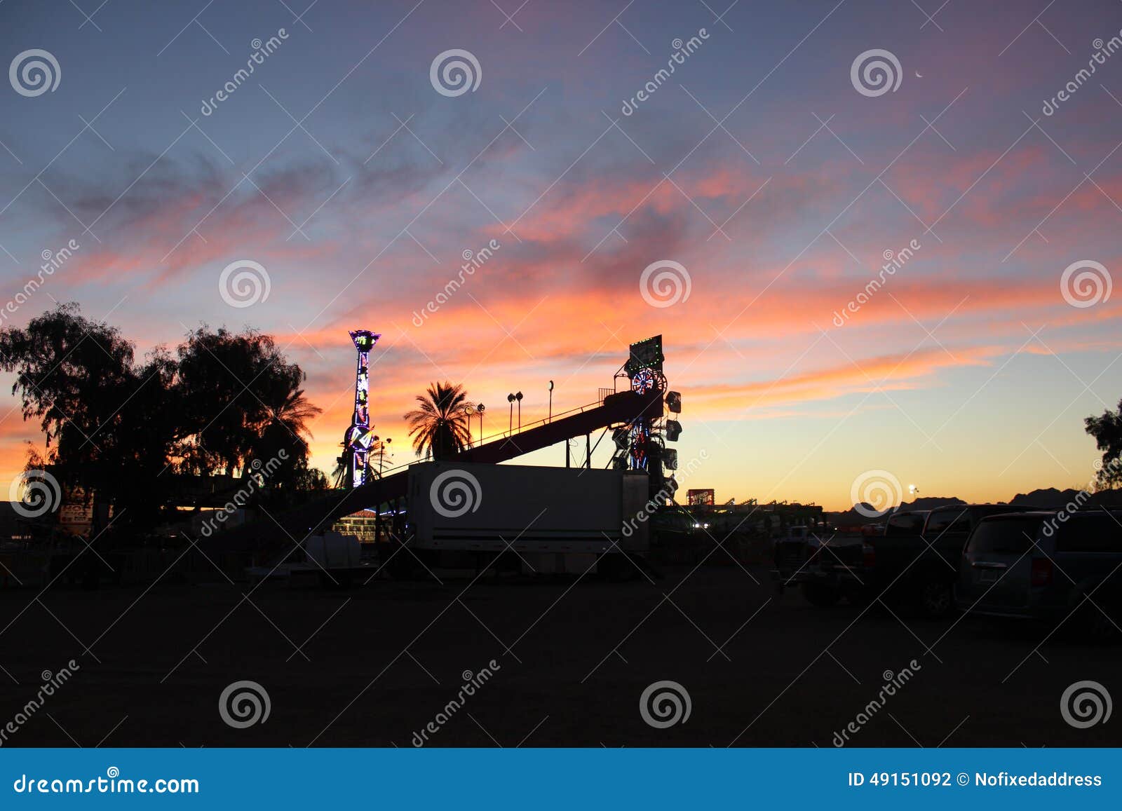 Sunset over carnival rides stock photo. Image of rides - 49151092