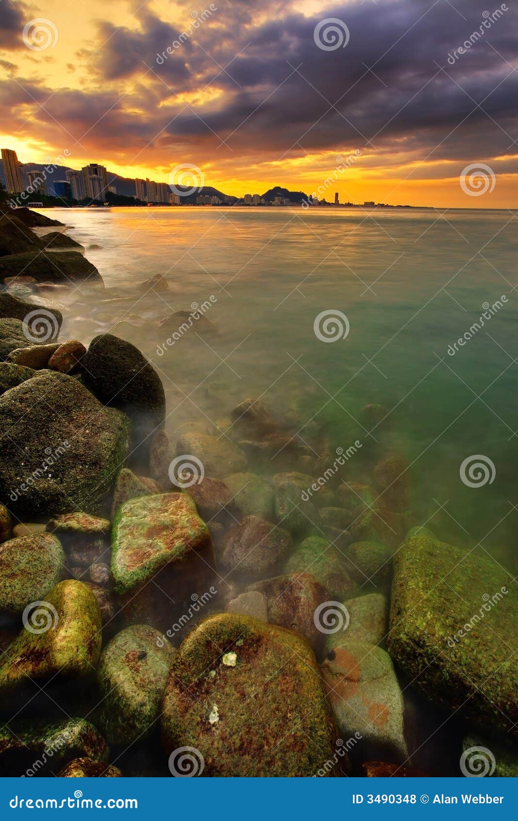 Sunset over city and ocean stock photo. Image of water - 3490348