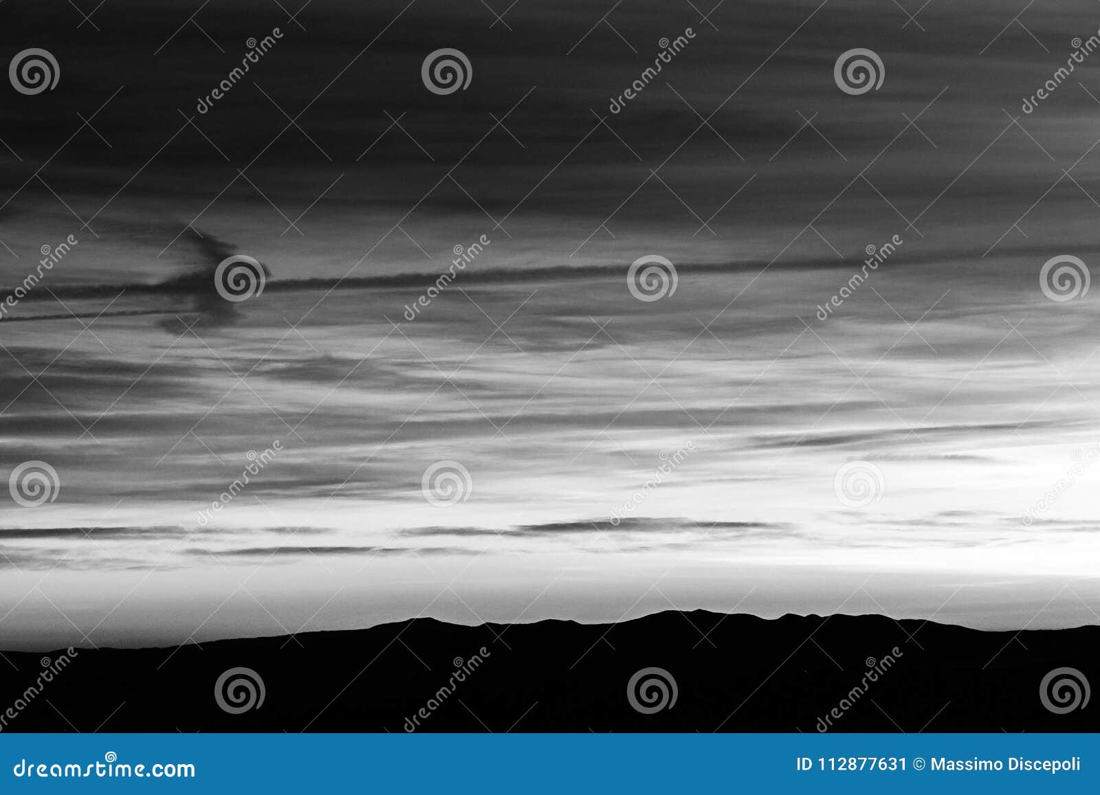 Sunset Over Distant Mountains, with Deep Sky Full of White Clouds and ...