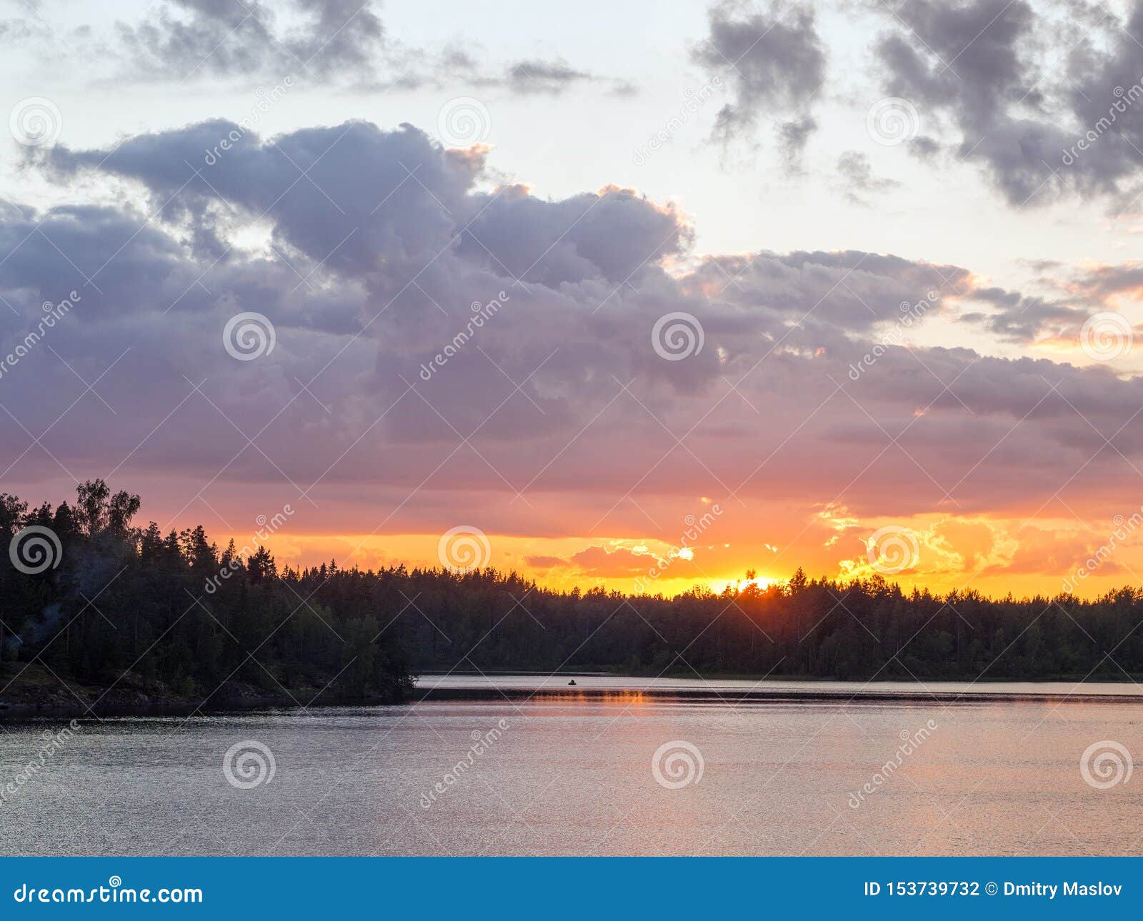 Sunset over a forest lake stock photo. Image of sunset - 153739732