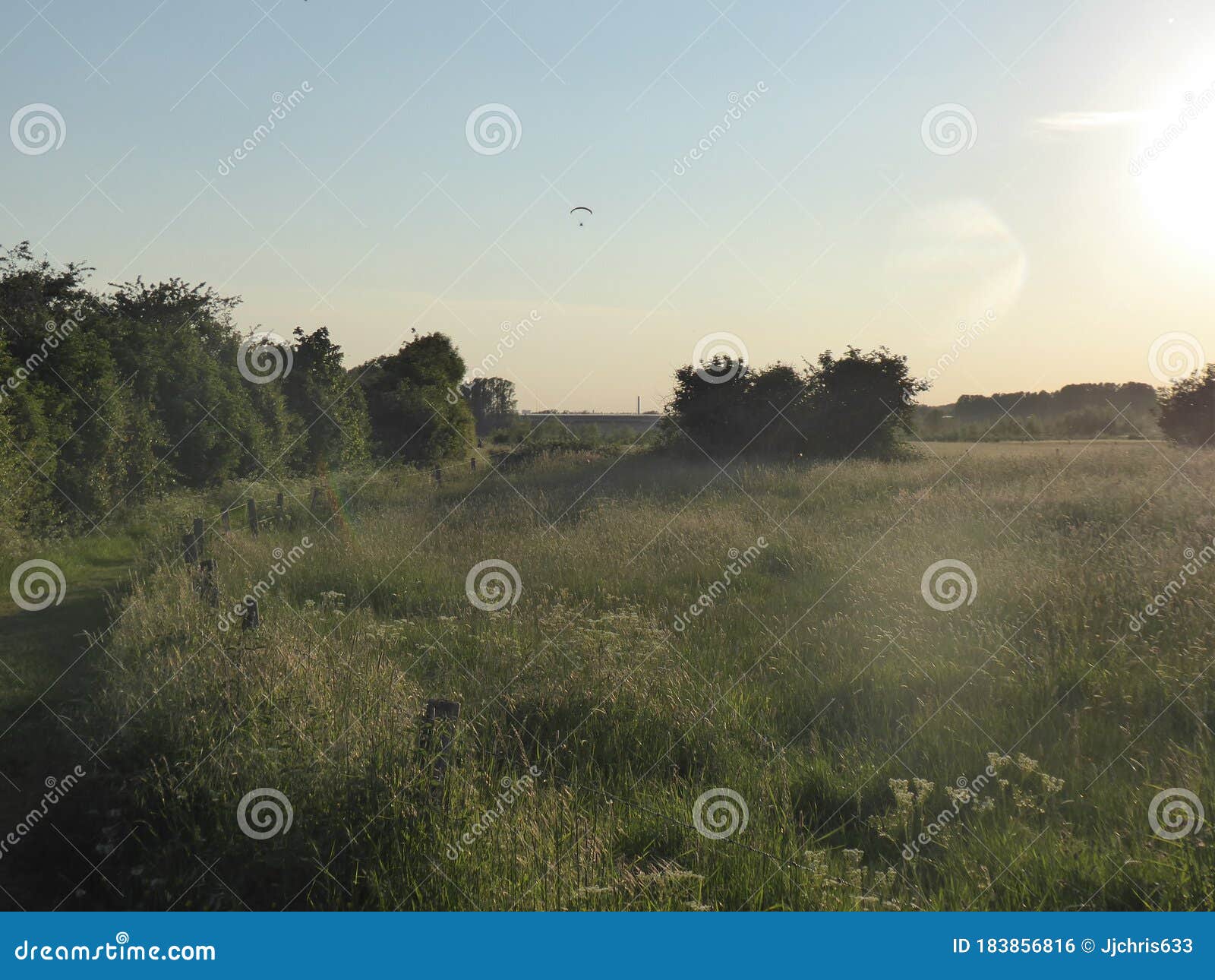 Sunset Over Grass Fields with Fences and a Path. Stock Photo - Image of ...