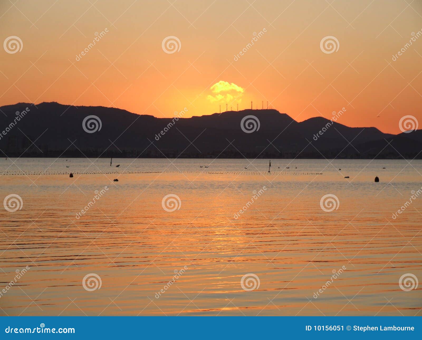 Sunset Over Land and Sea stock image. Image of mountain - 10156051