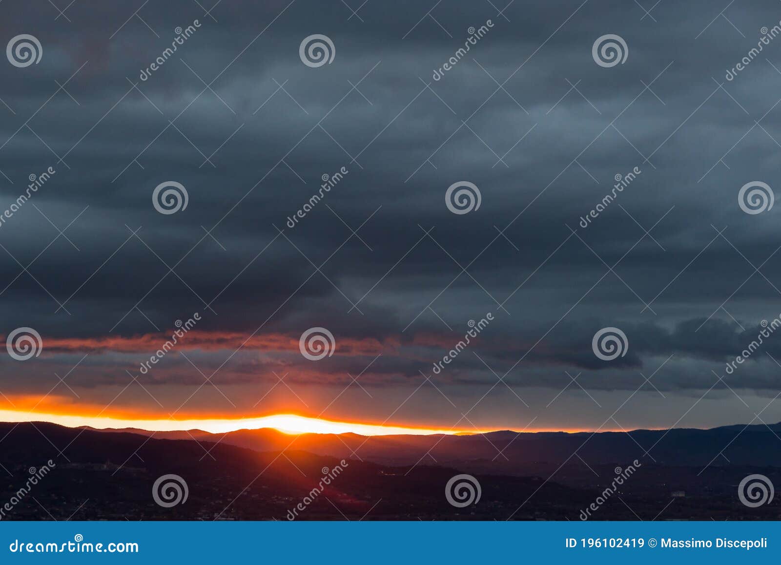 Sunset Over Mountains and Valley, with Sun Coming Down through an Hole ...
