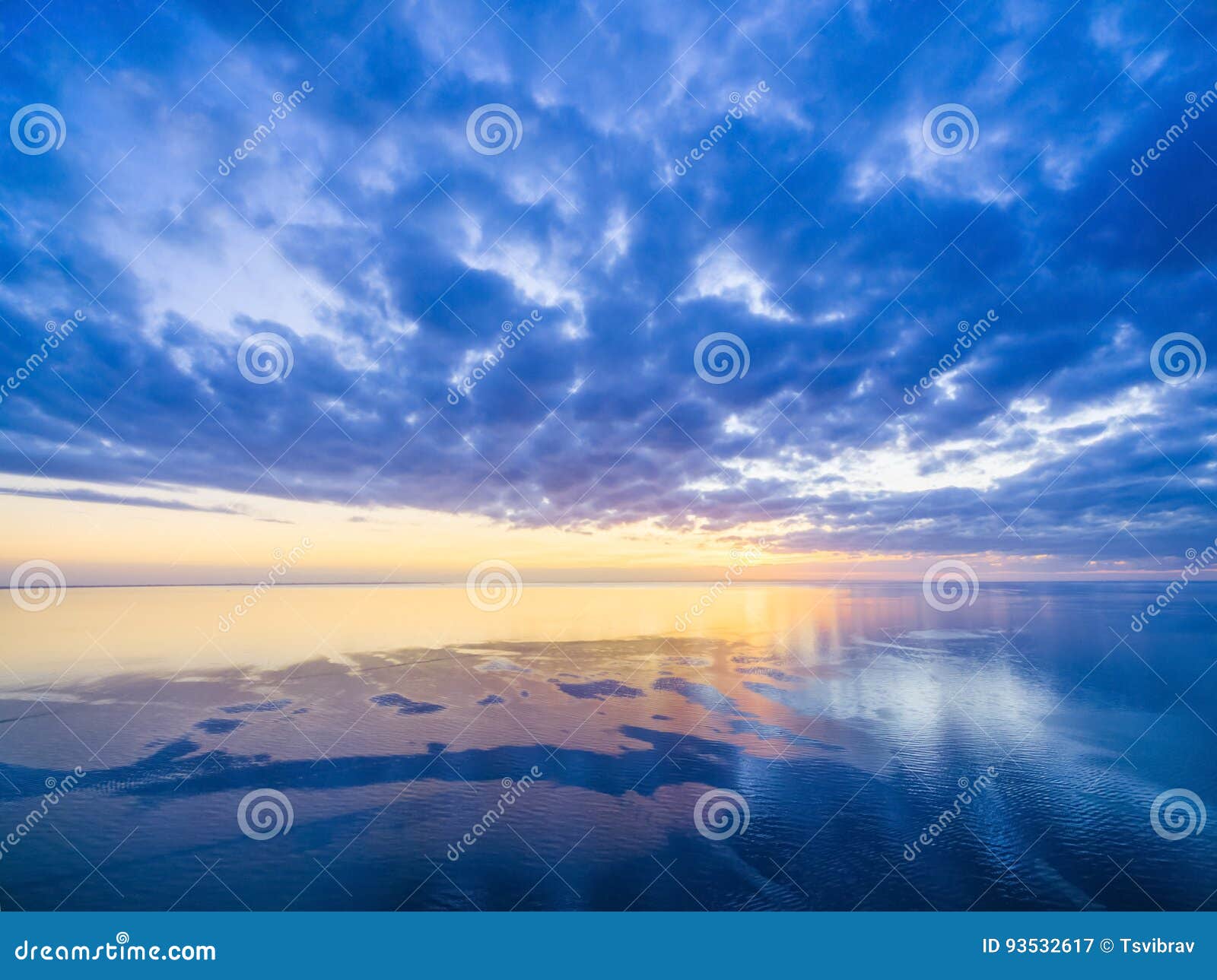 Sunset Over Ocean - Blue Cloudy Sky, Sun, and Smooth Water. Stock Image ...