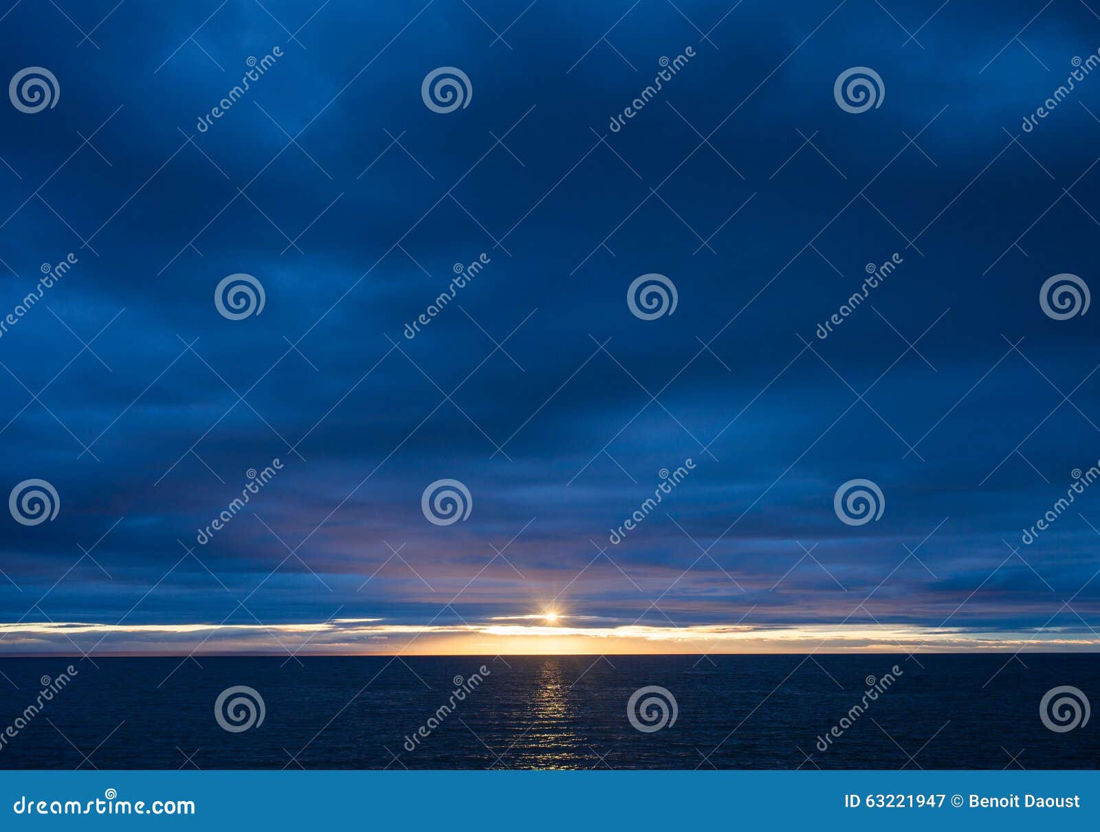 Sunset Over Ocean on a Dark Cloudy Evening Stock Image - Image of ...