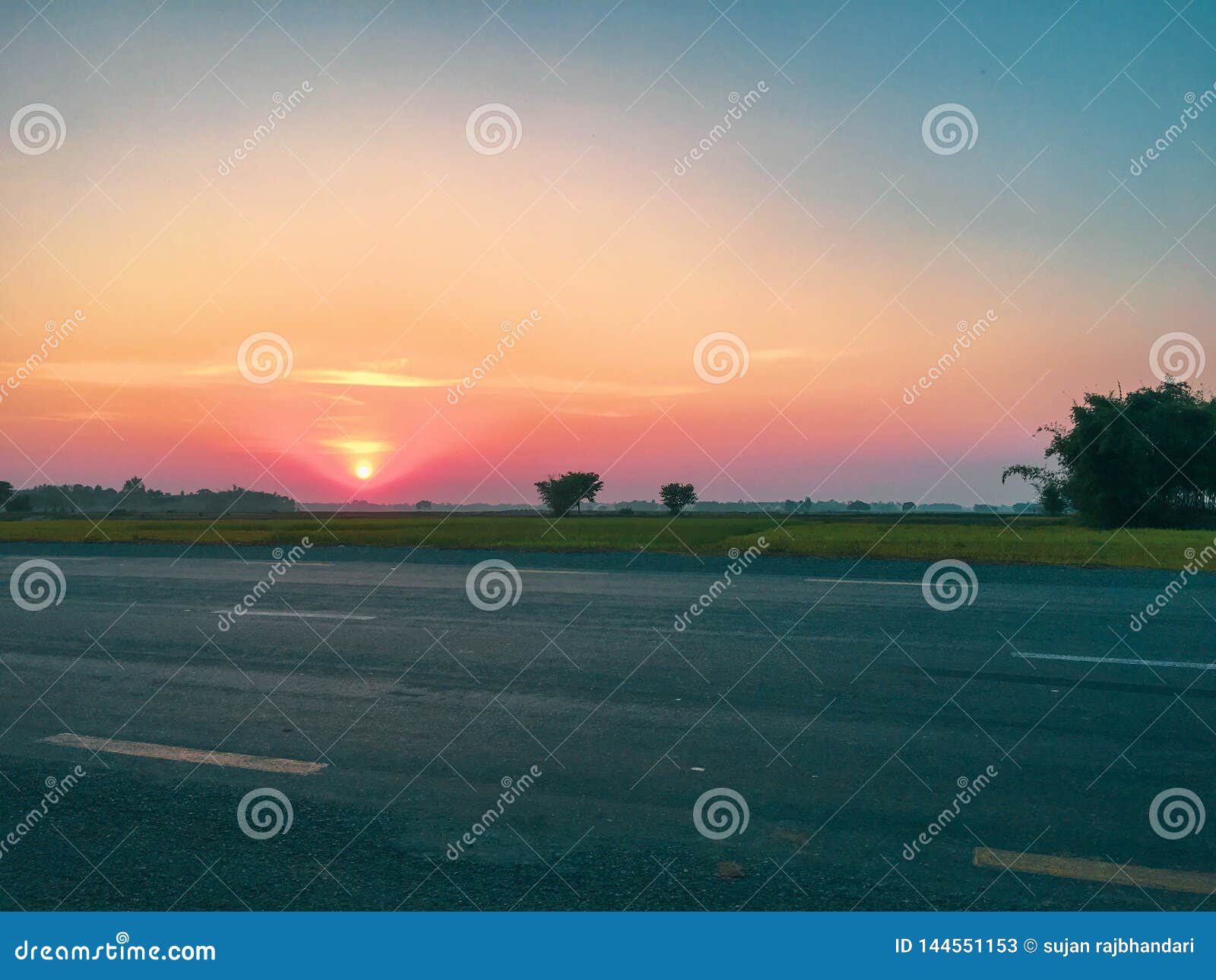 Sunset over road in terai stock image. Image of sunset - 144551153