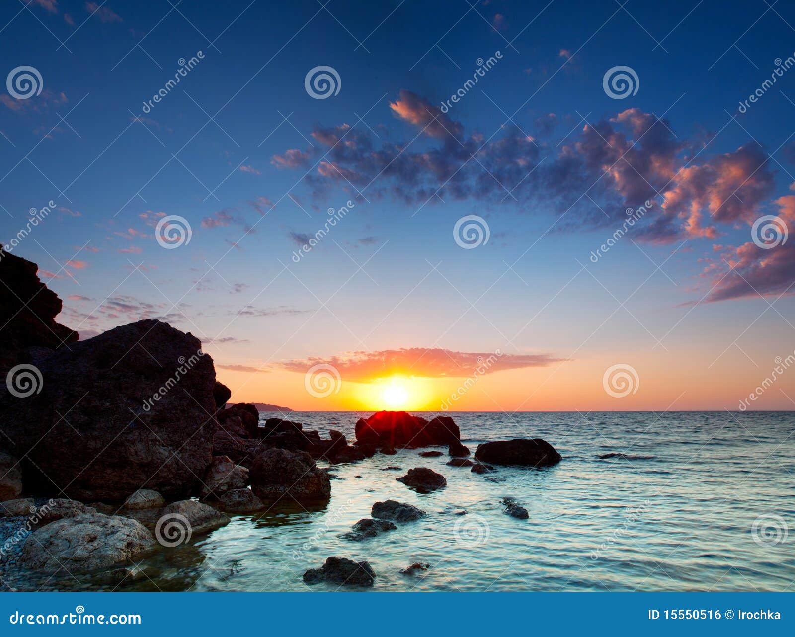 Sunset over rocky coast stock photo. Image of peaceful - 15550516