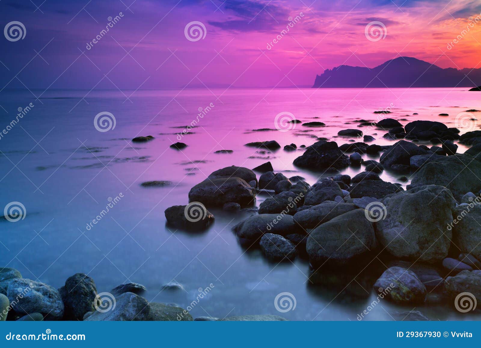 Sunset over a rocky coast stock photo. Image of beam - 29367930