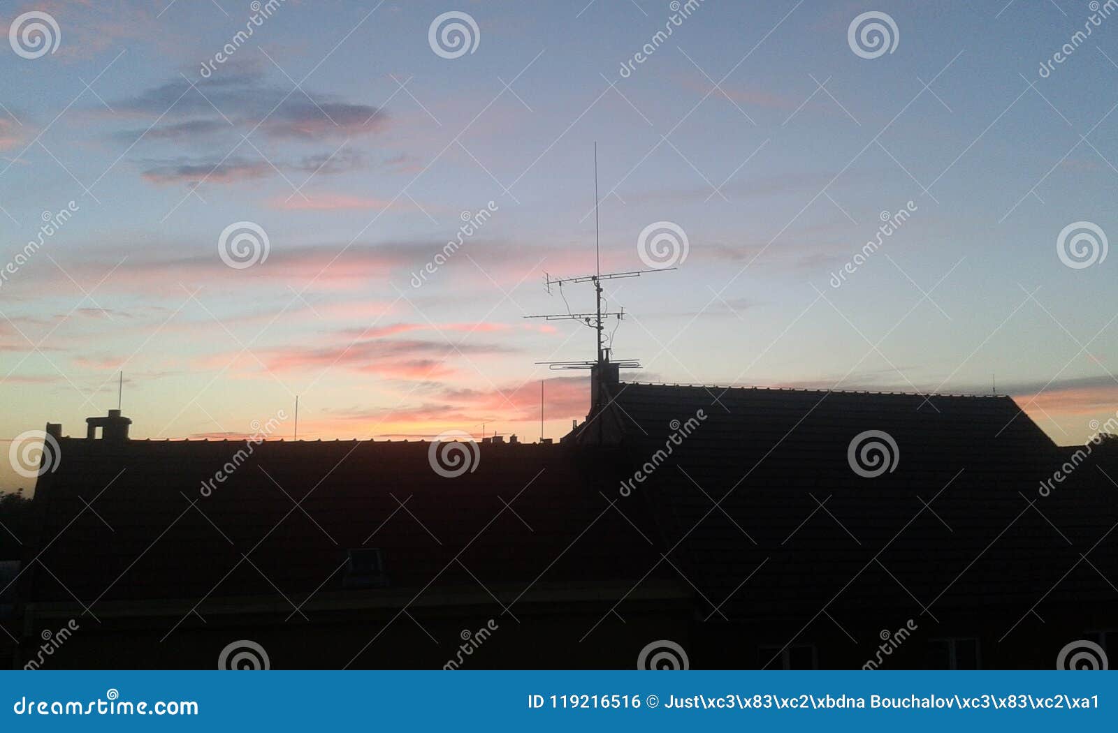Sunset over rooftop stock photo. Image of sunset, dark - 119216516