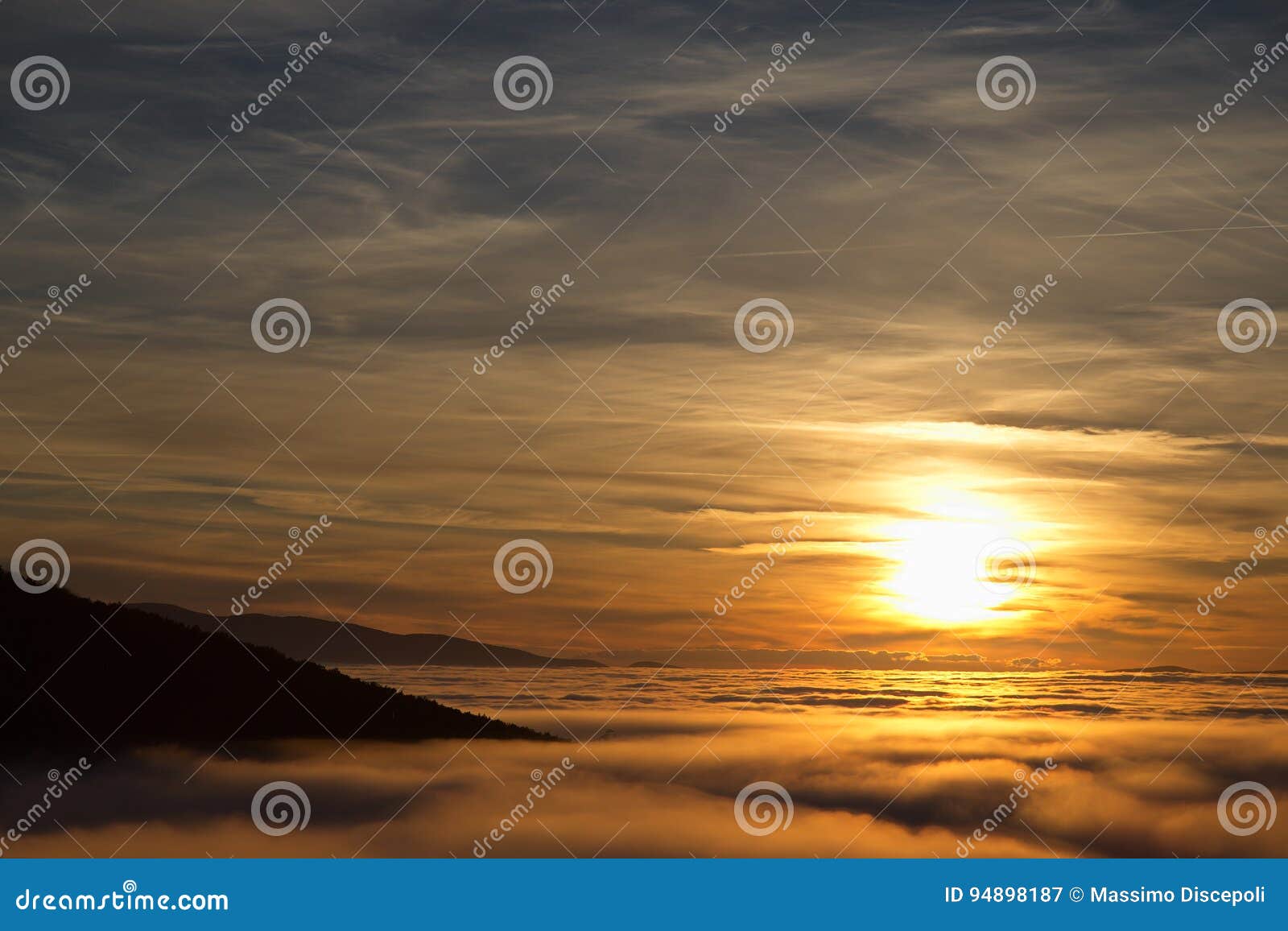 Sunset over a sea of fog stock image. Image of mountain - 94898187