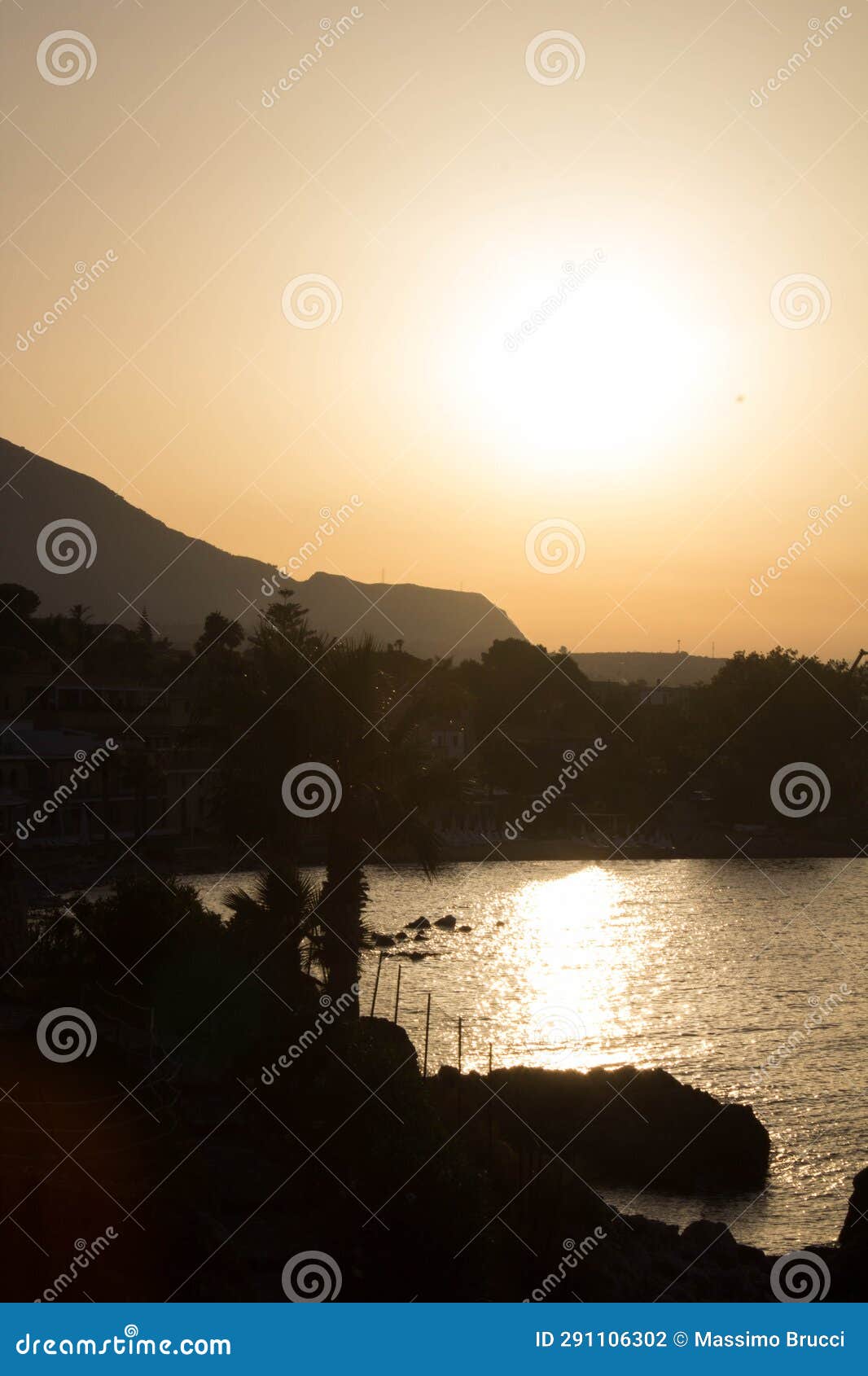 Sunset Over the Sea with Promontory Silhouette in the Background Stock ...