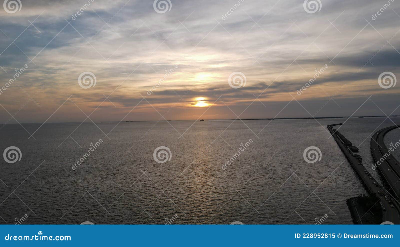 Sunset over Skyway stock image. Image of horizon, reflection - 228952815