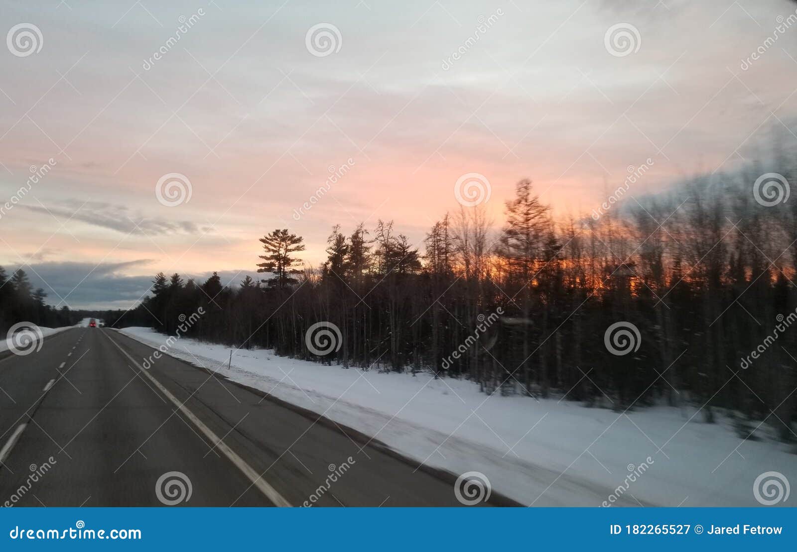 Sunset over the treeline stock image. Image of driving - 182265527