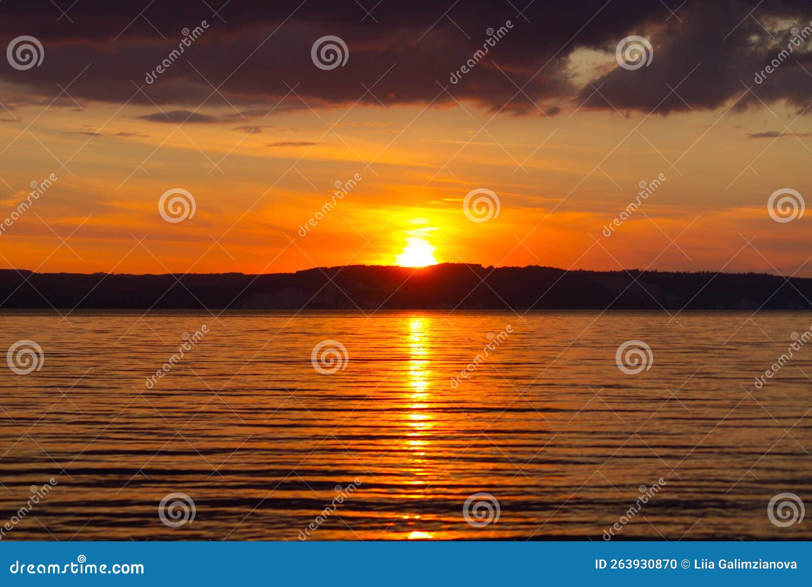 Sunset over the water stock photo. Image of landscape - 263930870