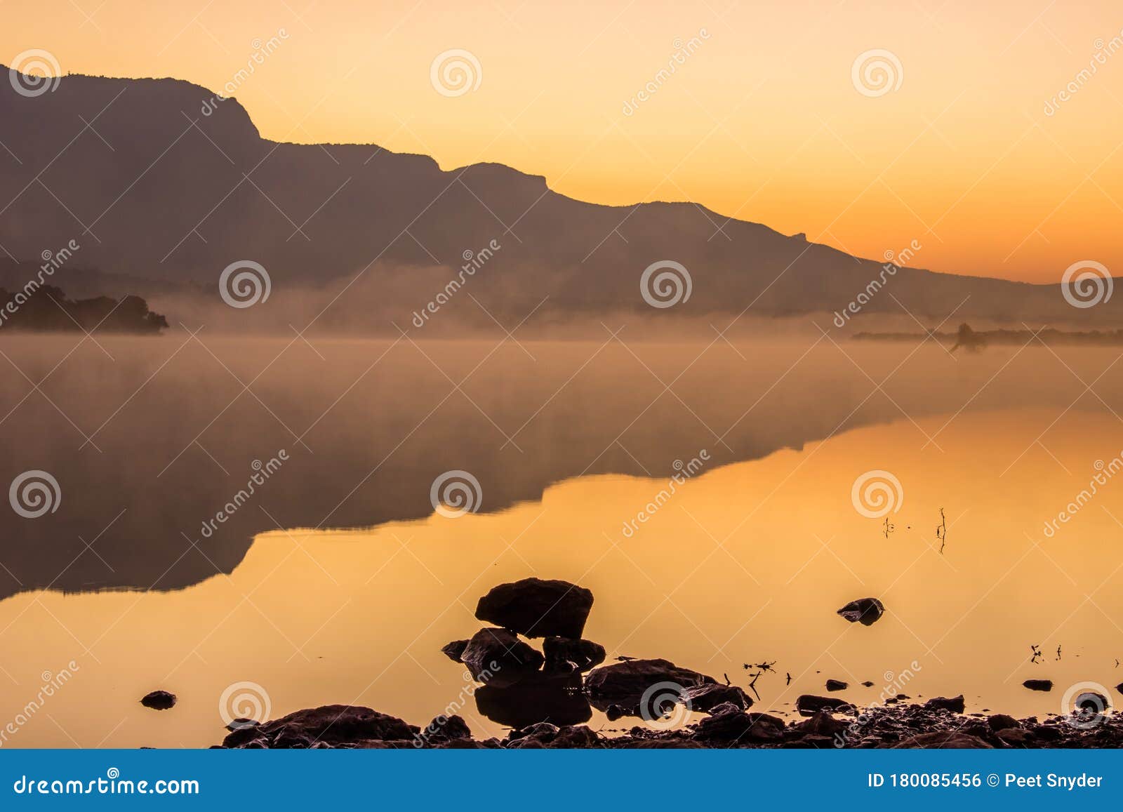Sunset Over Water with Rocks Stock Photo - Image of morning, cloud ...