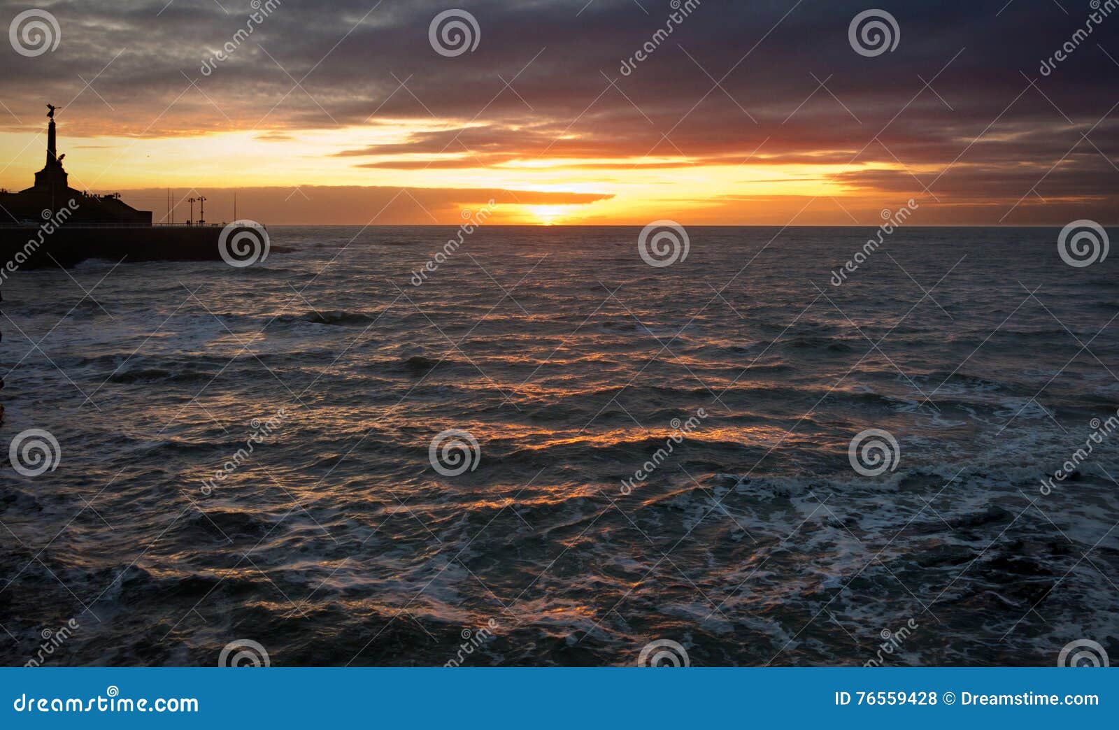 Sunset over the waves stock photo. Image of pebbles, horrizon - 76559428